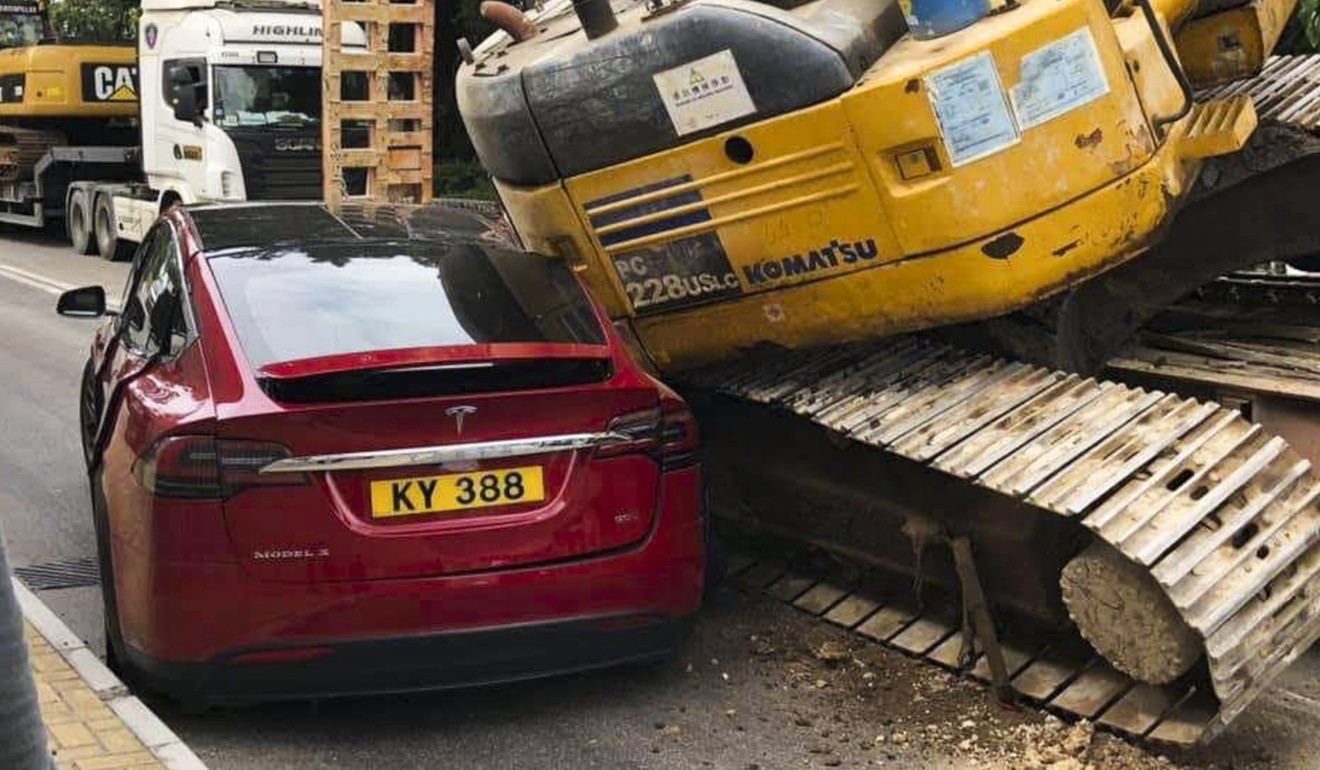 Bulldozer falls from truck onto passing Tesla on Hong Kong road | South ...